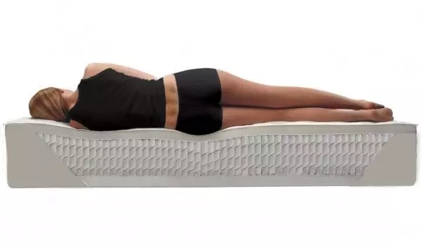 The girl lies on an orthopedic mattress