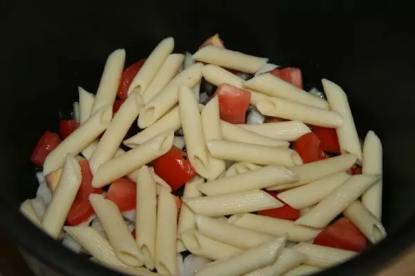 Boiled pasta with vegetables in a multicooker bowl