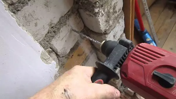Drilling holes for anchor in the wall