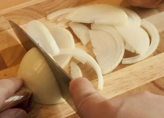 Slicing onion by half rings