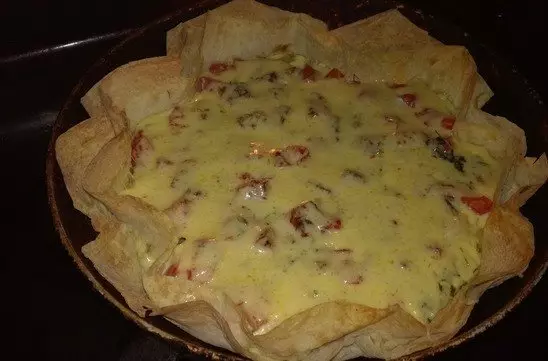 Ready scrambled eggs in pita with vegetables, sausage and cheese