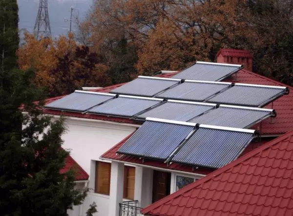 Solar-keräilijöiden järjestelmä yksityisen talon katolla