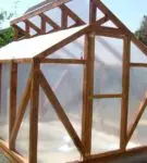 Wooden greenhouse with an unusual roof