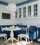Синьо-біла кухня в морському стилі з сучасною люстрою