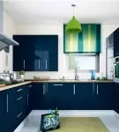 Тъмносини мебели и зелени части в кухненската атмосфера