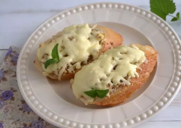 Hot sandwiches with canned fish, eggs and cheese on a plate