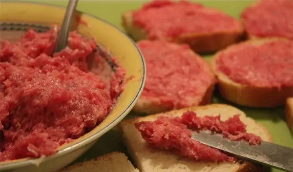 Raw mince in a big bowl and on white bread