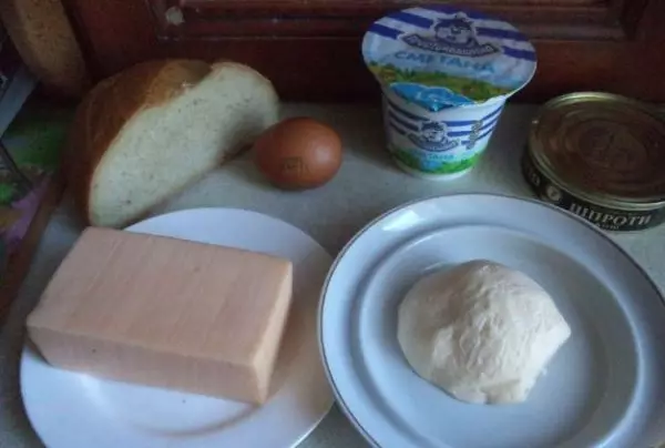 Products for cooking hot sandwiches with sprats and cheese on the table