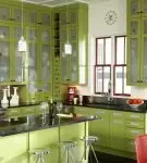 Mobiliario verde claro e elementos vermellos na cociña