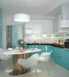 Bright wallpaper in a large kitchen with white and blue furniture