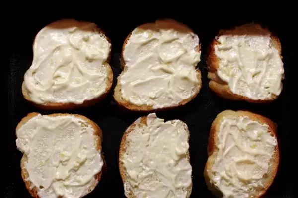 Pieces of bread with mayonnaise in contradict