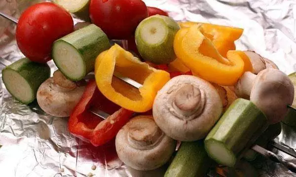 Stained on skewers vegetables and champignons