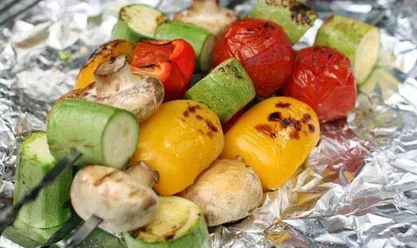 Ready kebab from vegetables and champignons on foil for baking