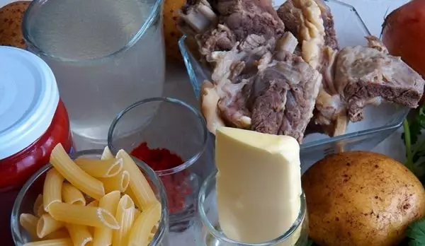 Productos para cocinar sopa de carne con torcarones y papas en la mesa.