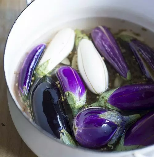 Little eggplants in a saucepan with marinade