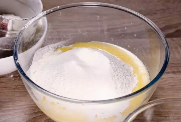 Flour in a bowl with whipped eggs