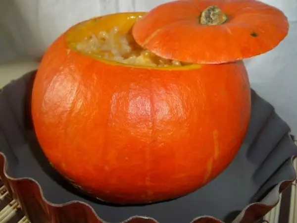 Stuffed pumpkin in a round metal form for baking