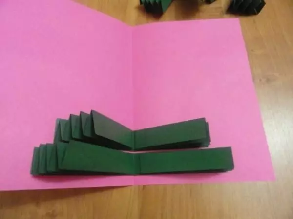 Forming paper Christmas tree in cardboard basis for postcard