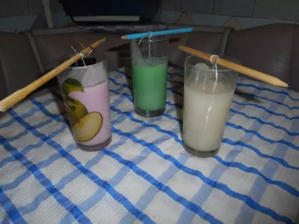 Homemade multicolored candles in glasses