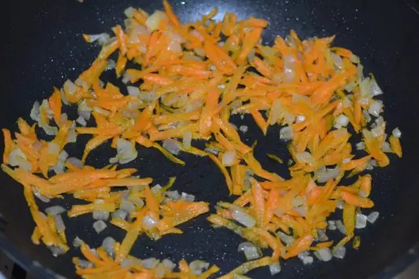 Onions and carrots in a pan