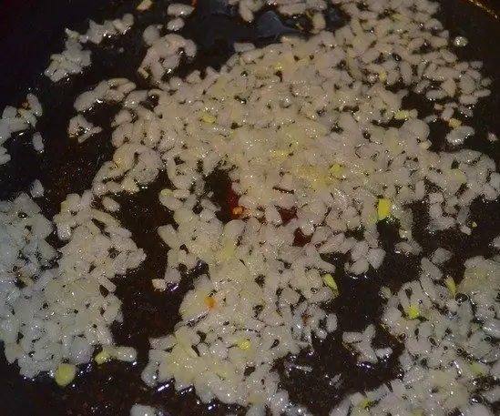 Grinding onions in a frying pan