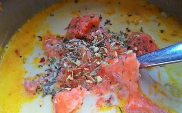 Cheese soup with red fish and dry herbs