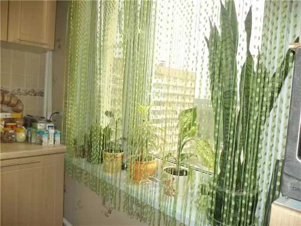 Curtains in the form of ribbons in the kitchen