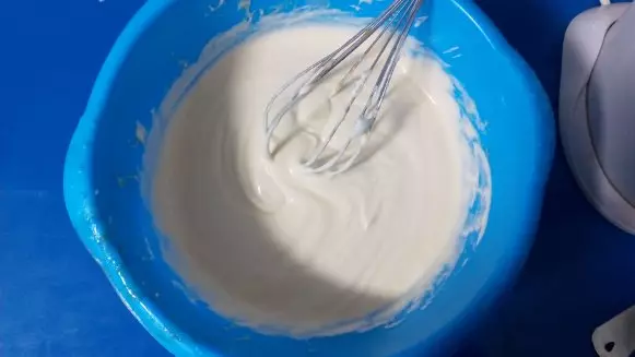 Creamy cream sa usa ka plastik nga panaksan ug usa ka metal nga whine