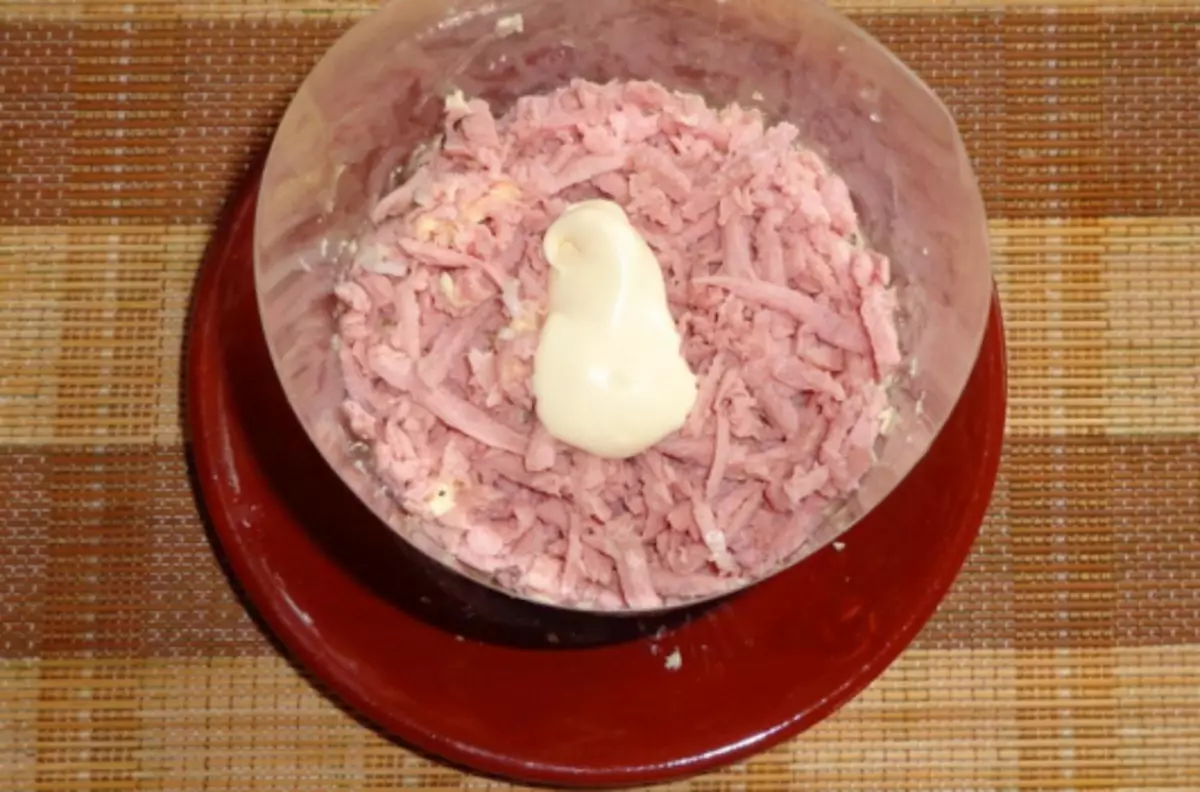 Curly boiled sausage and mayonnaise in the molding ring