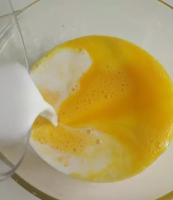 Mezcla de leche y huevos azotados en tanque de vidrio.