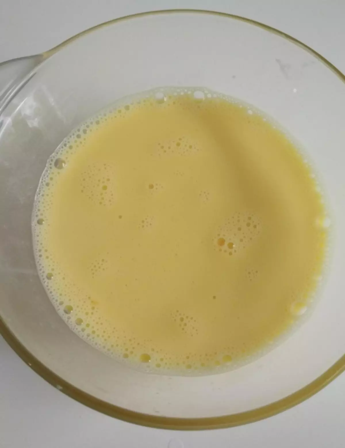 Blend of milk and eggs in a glass bowl