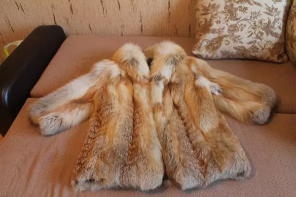 Fox fur coat lies on the sofa