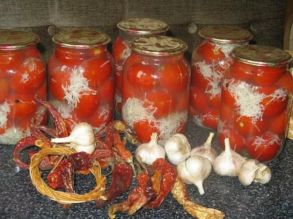 Tomatoes with garlic for winter in banks under metal covers