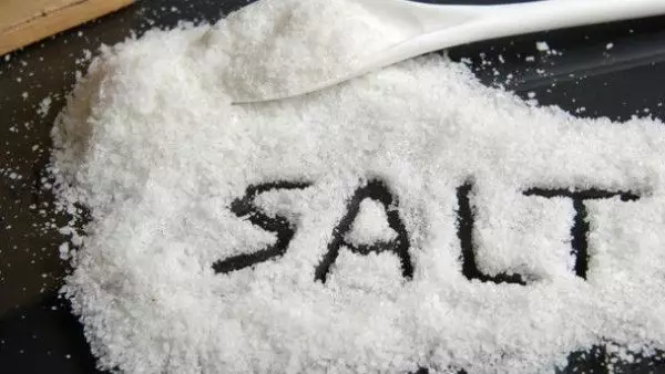 Word SALT on scattered salt on the table
